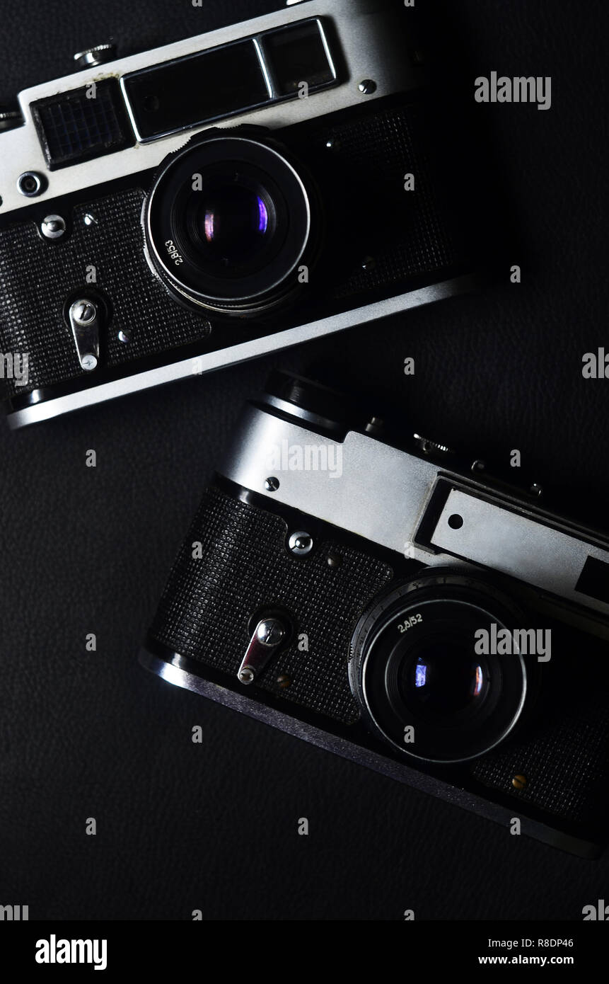 An old photo cameras from mid of 20th century on black leather ...