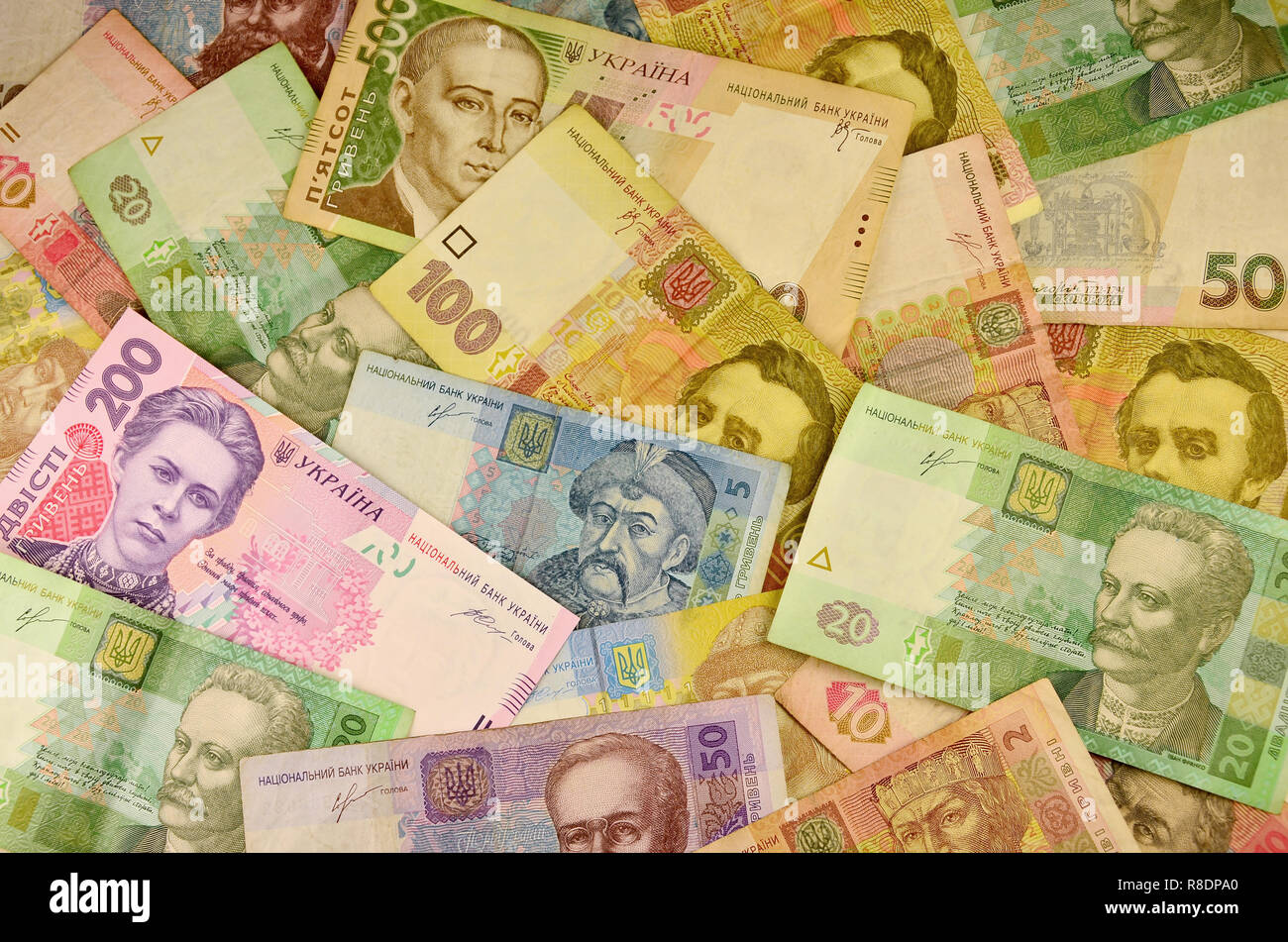 Background image of many Ukrainian banknotes of different colors and ...
