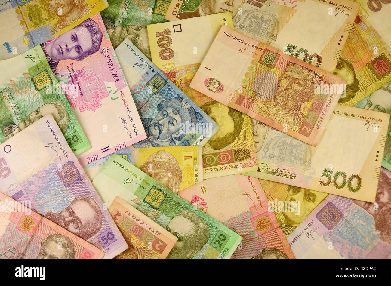 Many Ukrainian money bills of various denominations and colors ...