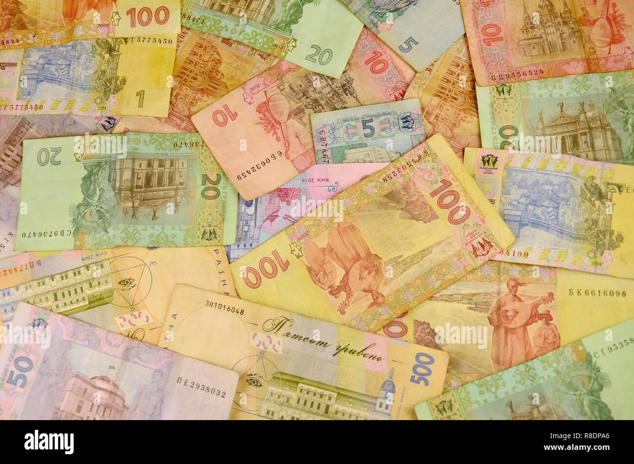 Many Ukrainian money bills of various denominations and colors ...