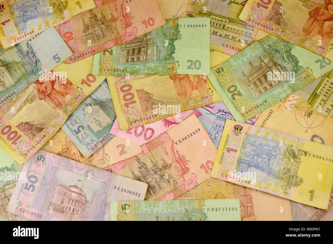 Background image of many Ukrainian banknotes of different colors and ...