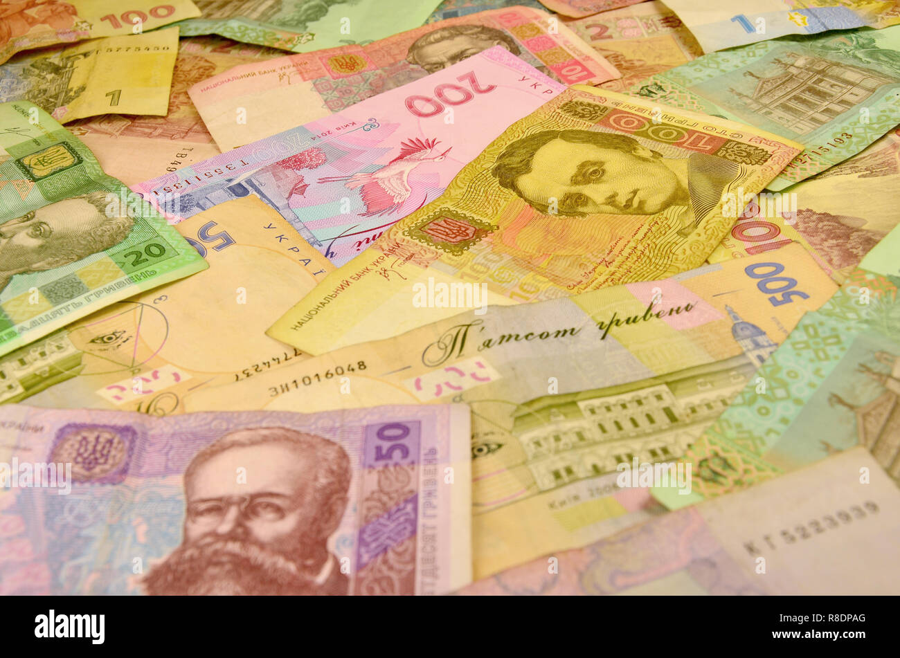 Many Ukrainian money bills of various denominations and colors ...