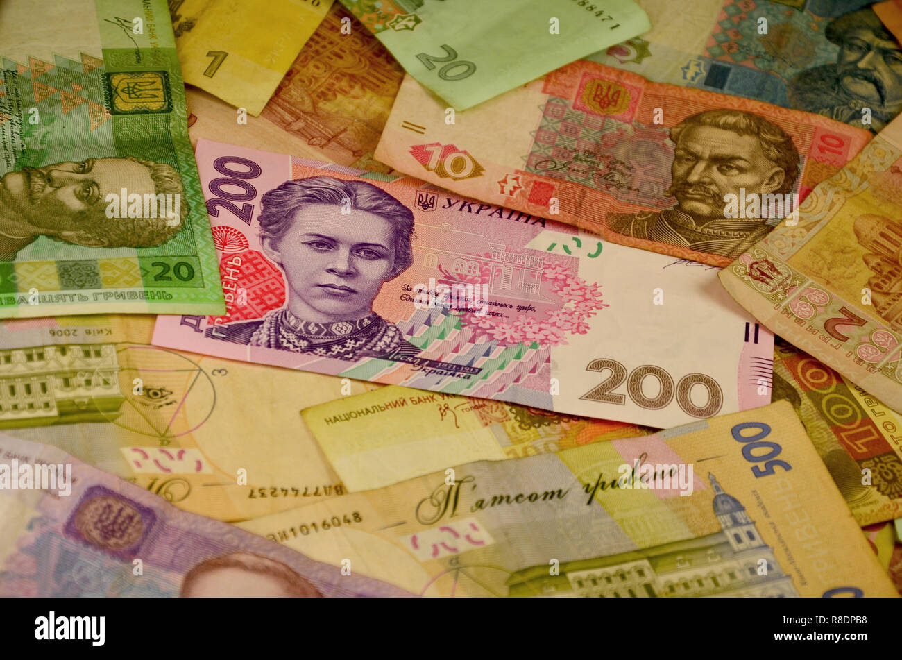 Many Ukrainian money bills of various denominations and colors ...