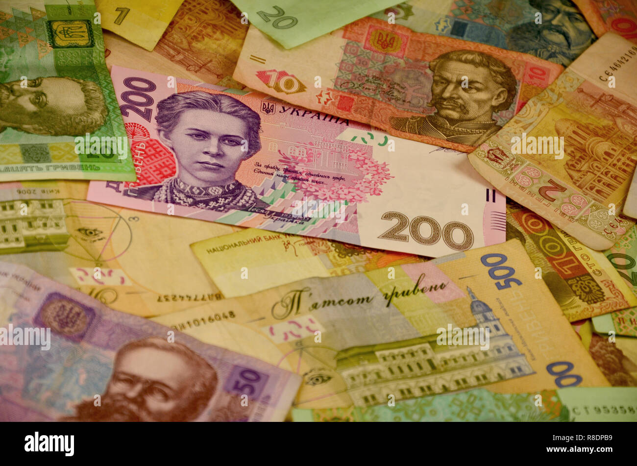 The background image of a pile of Ukrainian banknotes of different ...