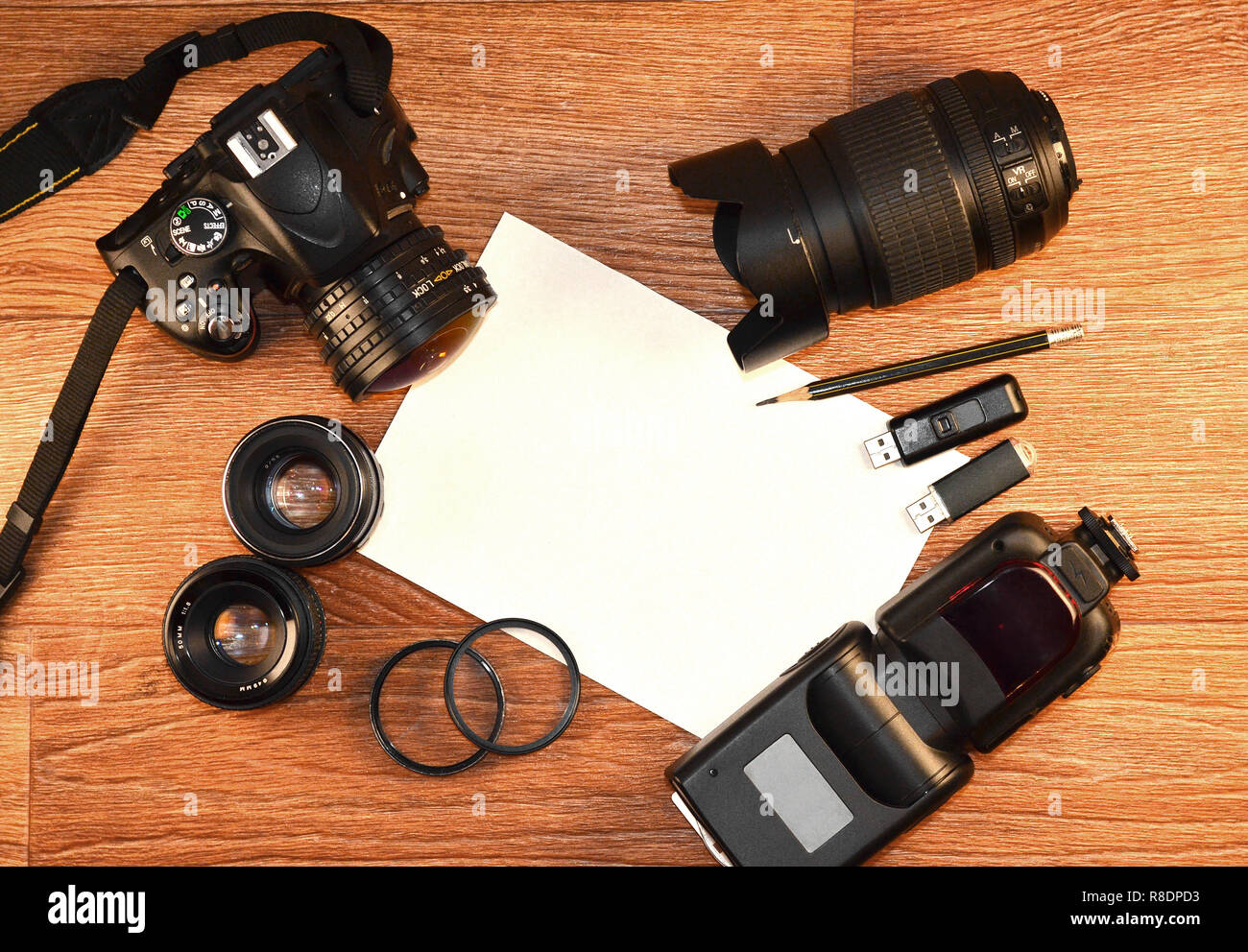 Complete kit for modern digital SLR camera and blank sheet of paper for ...