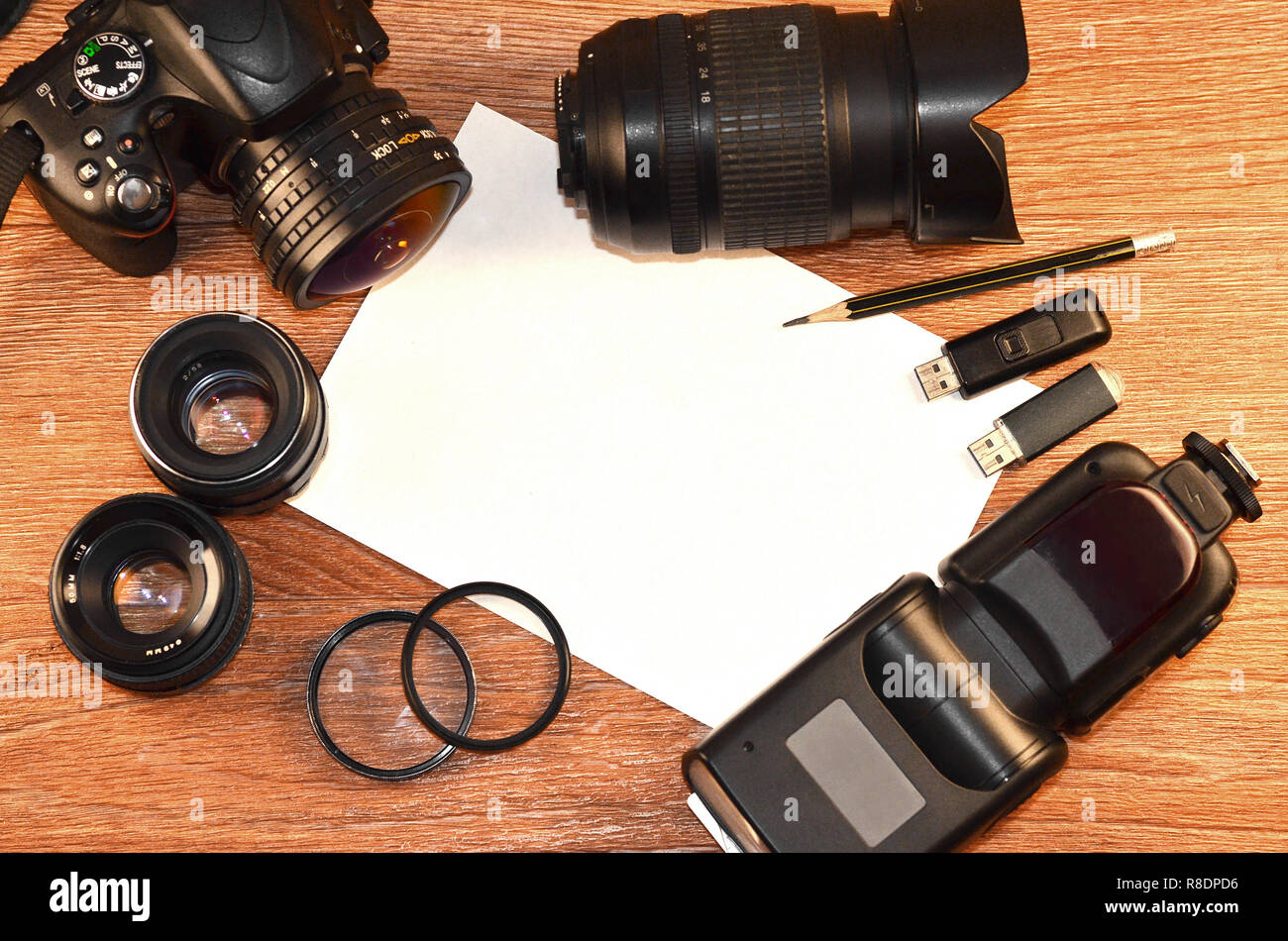 Complete kit for modern digital SLR camera and blank sheet of paper for ...