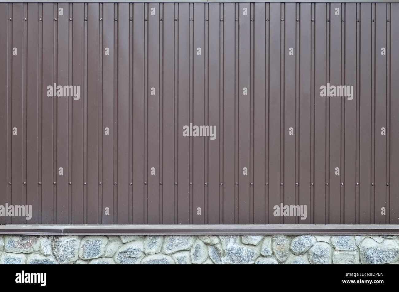Weathered stained metal wall texture with stone foundation. Metal wall ...