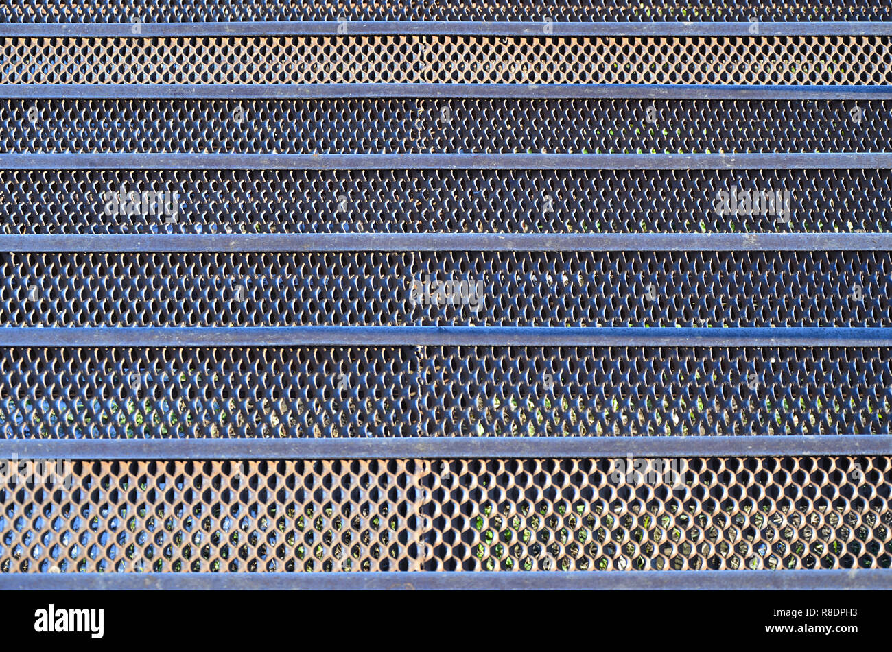Texture steps of rusty metal mesh in the sections of the metal strips ...