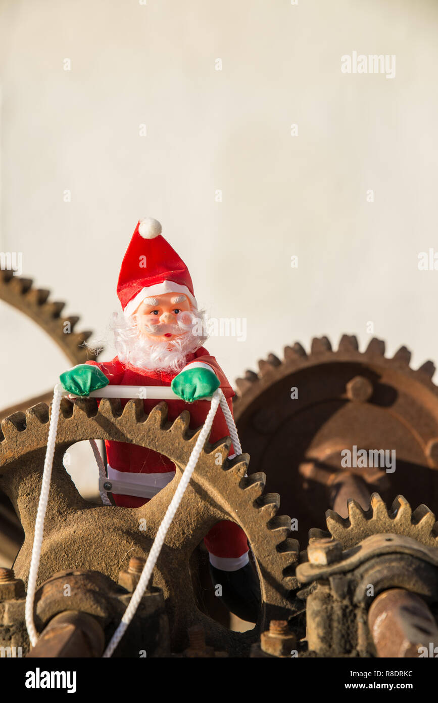 Santa in the cogwheels of consumerism, a concept Stock Photo - Alamy