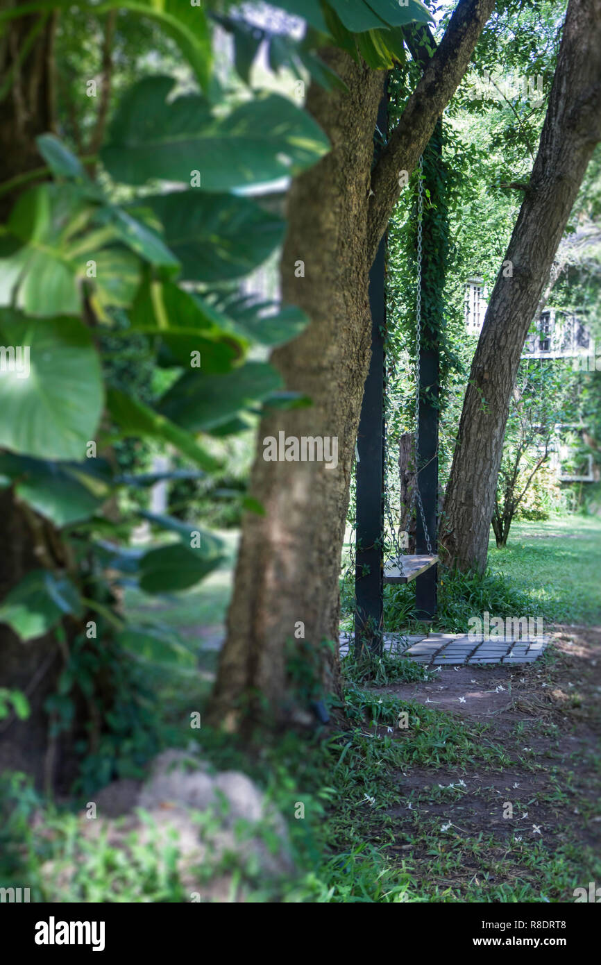 Relaxing spot in the garden with swing, stock photo Stock Photo - Alamy
