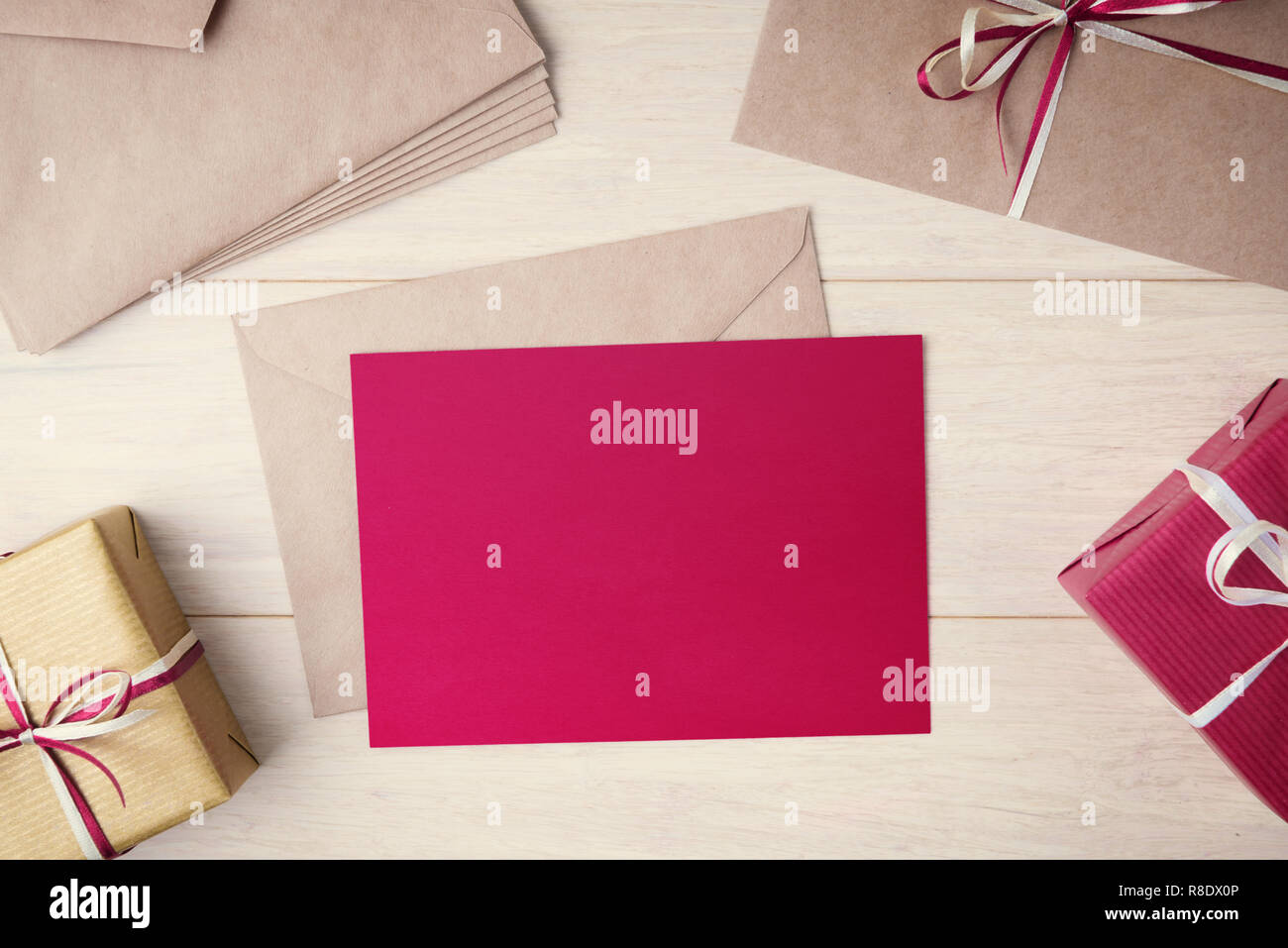 Blank red card mock up among envelopes and gift boxes Stock Photo - Alamy