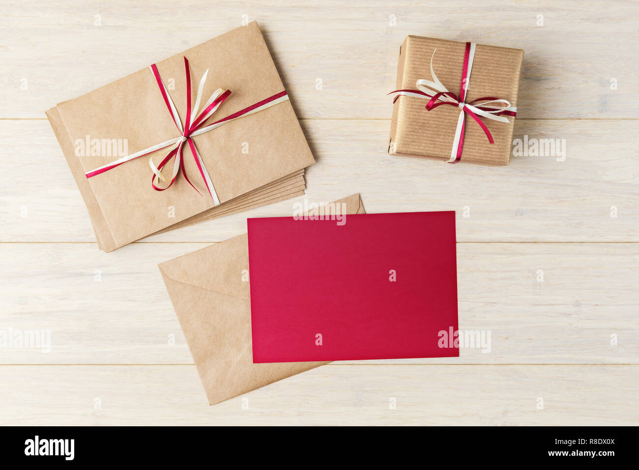 Blank red card mock up with envelopes and gift box Stock Photo - Alamy