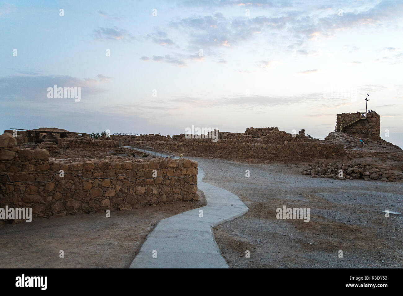 The tallest tower of Masada against the cloudy sky at dawn in the sun ...