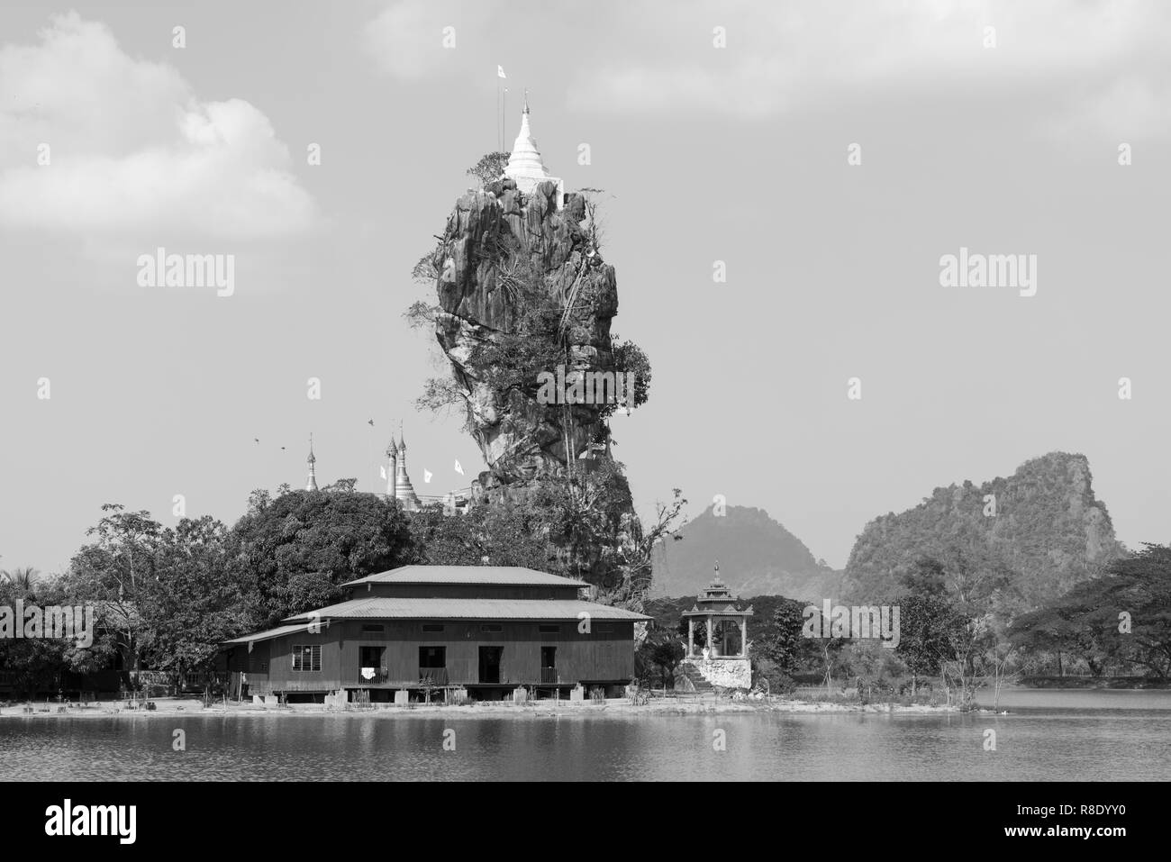 Black and white picture of Kyaut Ka Latt Pagoda built over the cliff in ...