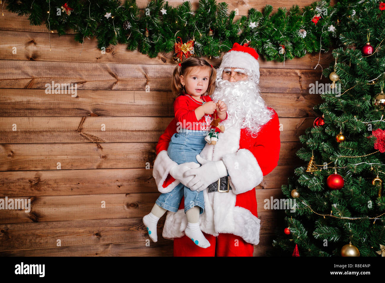 Santa Claus with smiling kid indoors christmas celebration concept ...