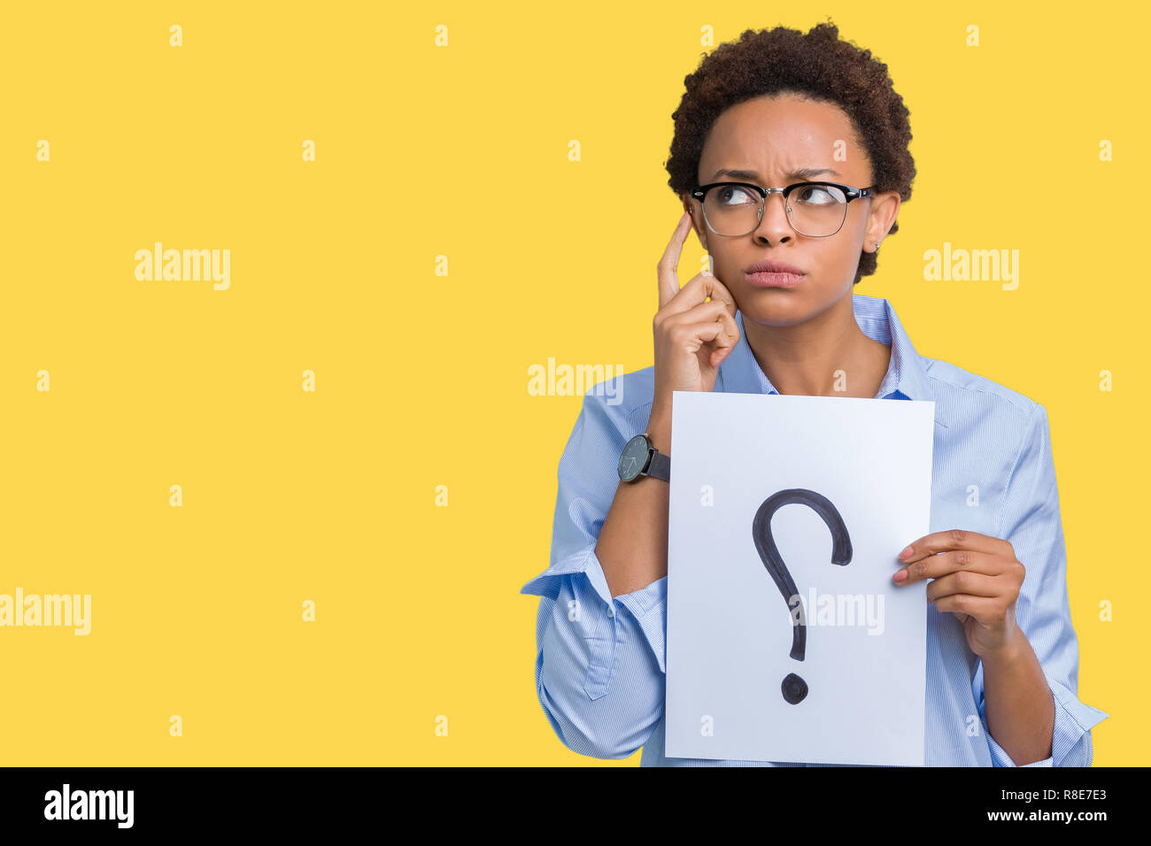 Young african american woman holding paper with question mark over ...