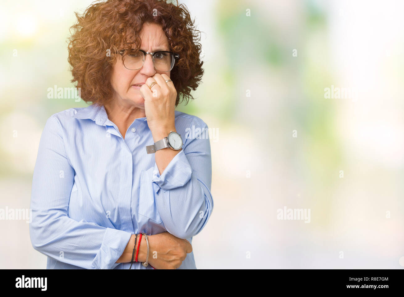 Beautiful middle ager senior businees woman wearing glasses over ...