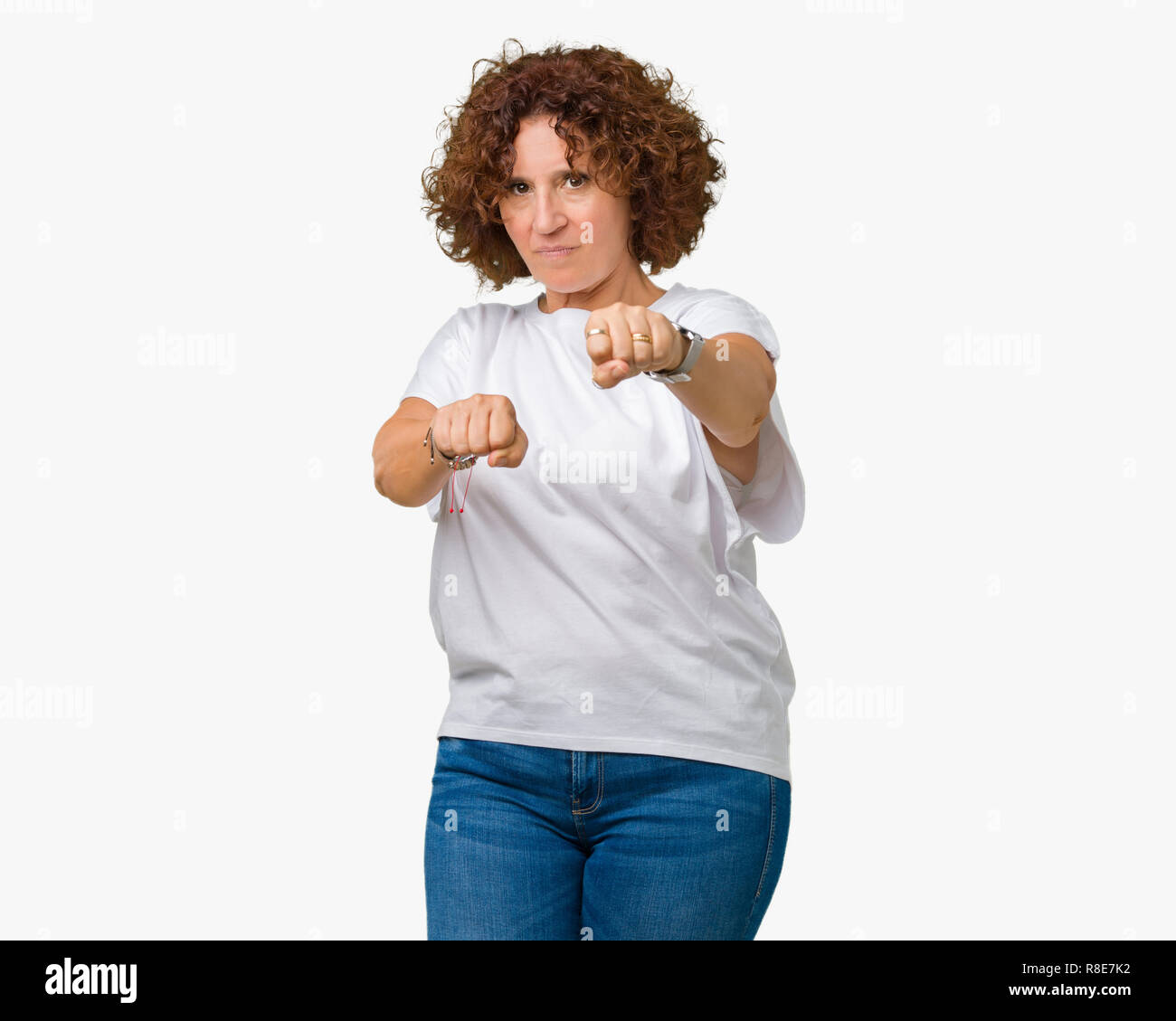 Beautiful middle ager senior woman wearing white t-shirt over isolated ...