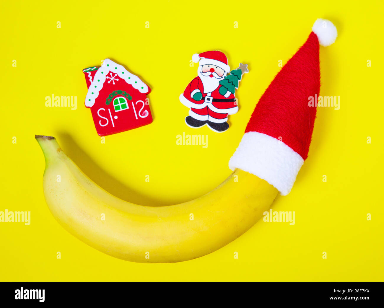 Christmas banana in Santa's cap on a yellow background Stock Photo - Alamy