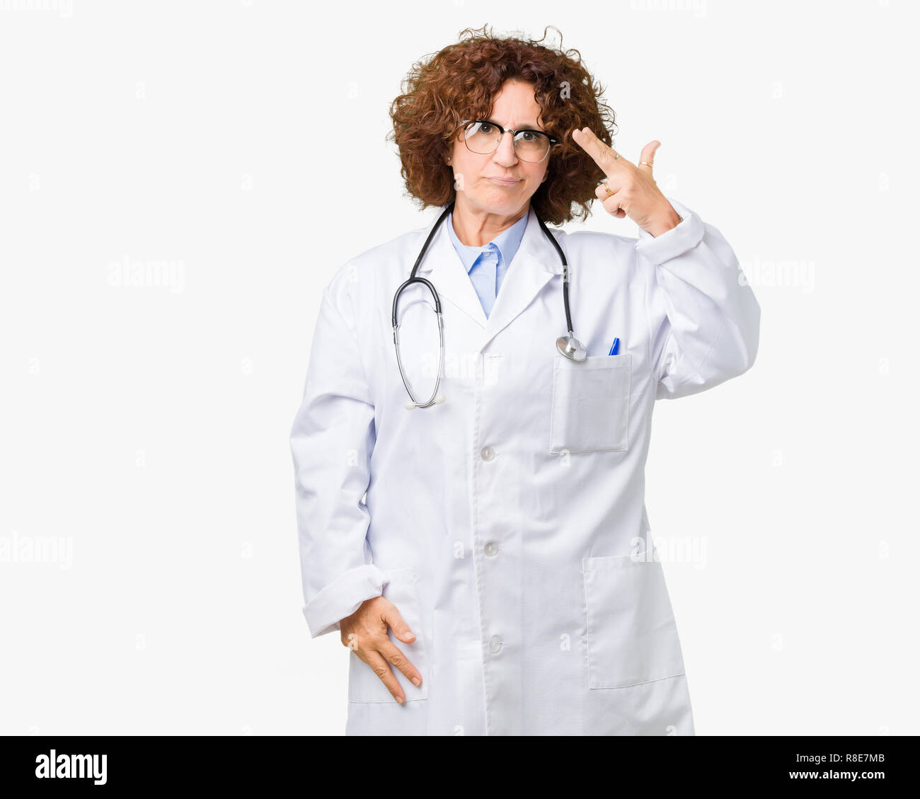 Middle ager senior doctor woman over isolated background Shooting and ...