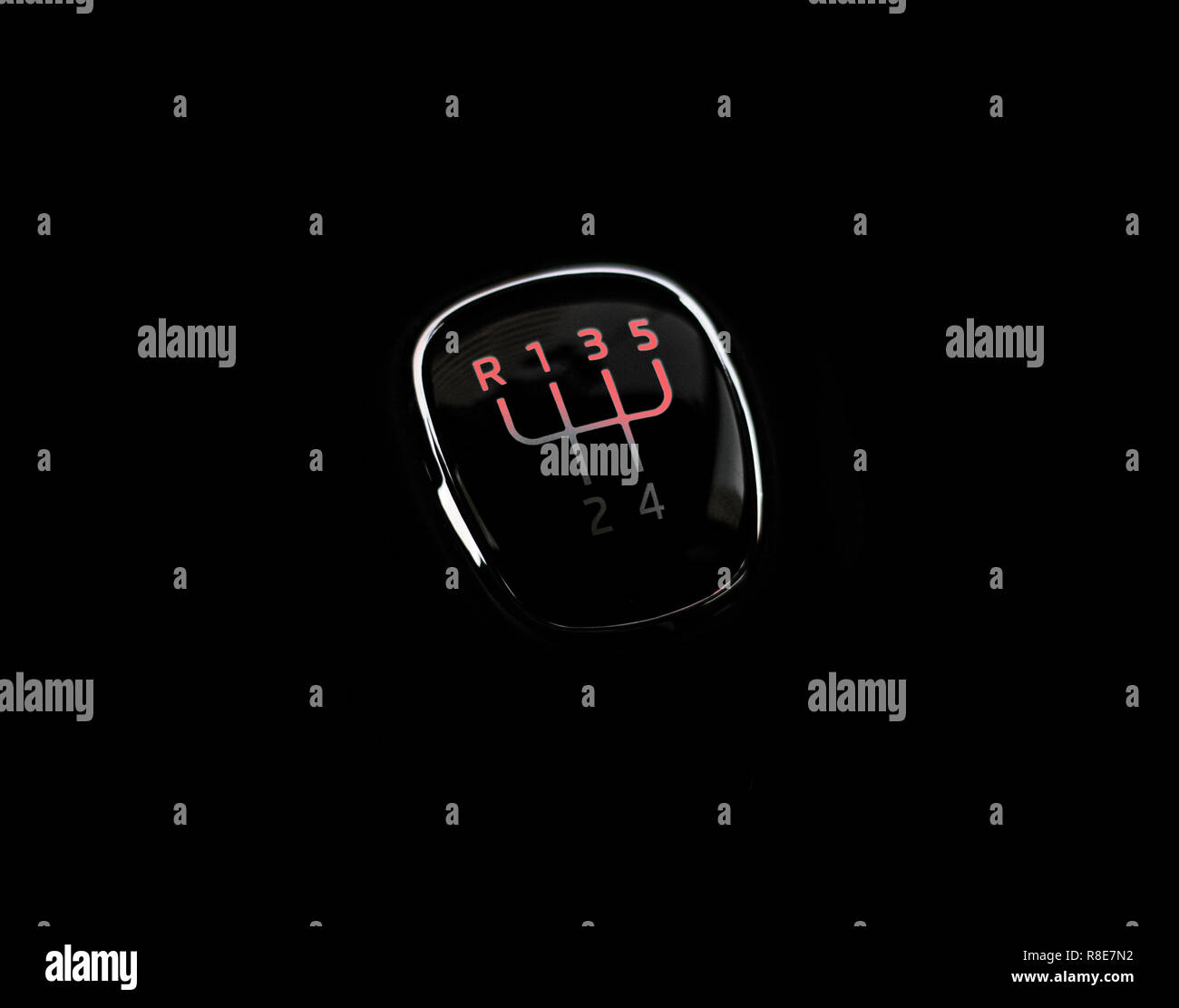 Manual transmission gear shift, on dark backgroun with red numbers ...