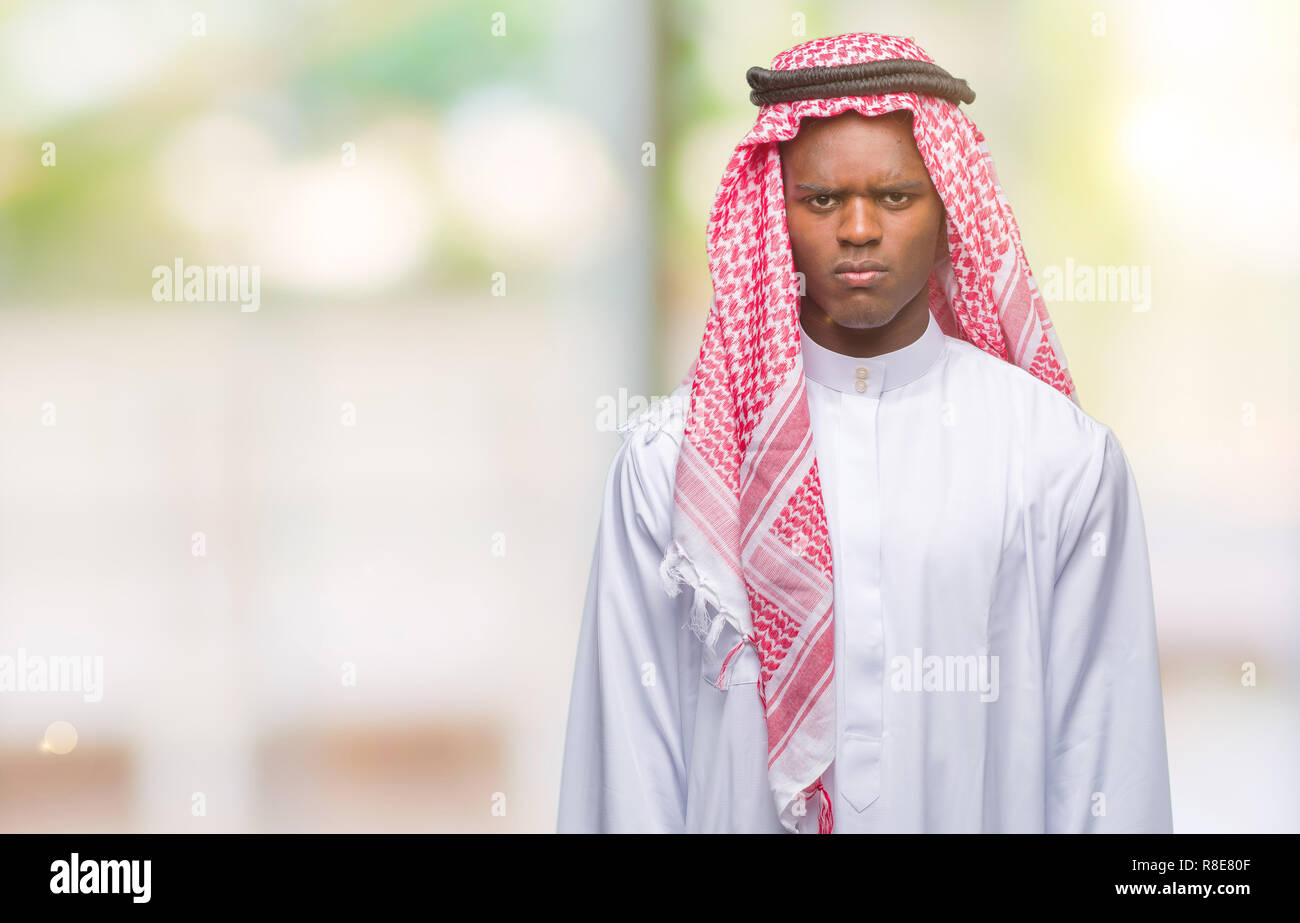 Young arabic african man wearing traditional keffiyeh over isolated ...