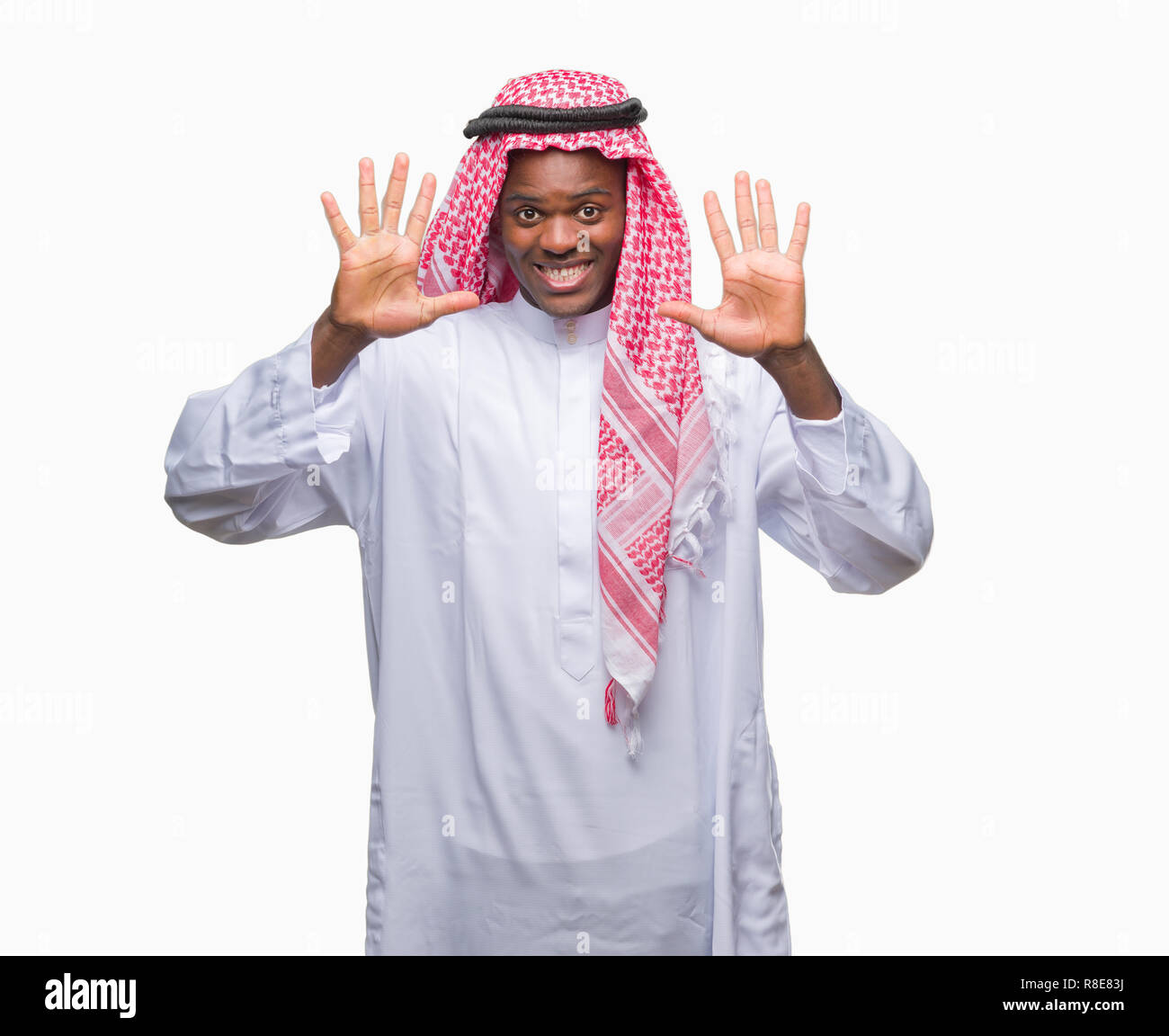 Young arabic african man wearing traditional keffiyeh over isolated ...