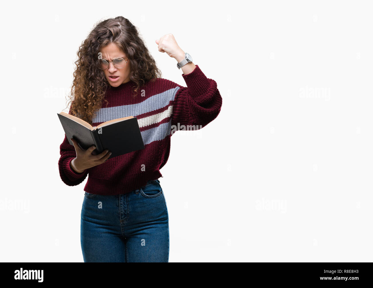Young brunette girl reading a book wearing glasses over isolated ...