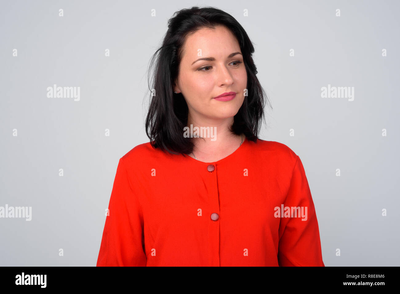 Beautiful woman with red dress thinking while looking down Stock Photo ...