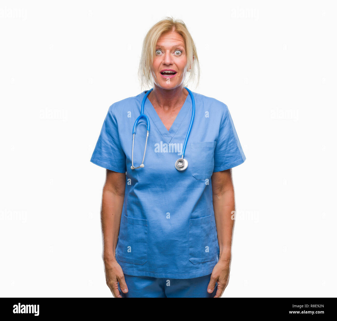 Middle age blonde nurse surgeon doctor woman over isolated background ...