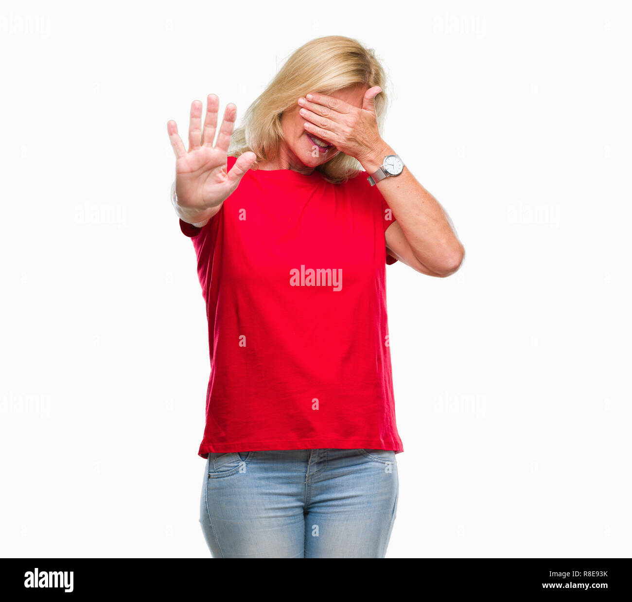 Middle age blonde woman over isolated background covering eyes with ...
