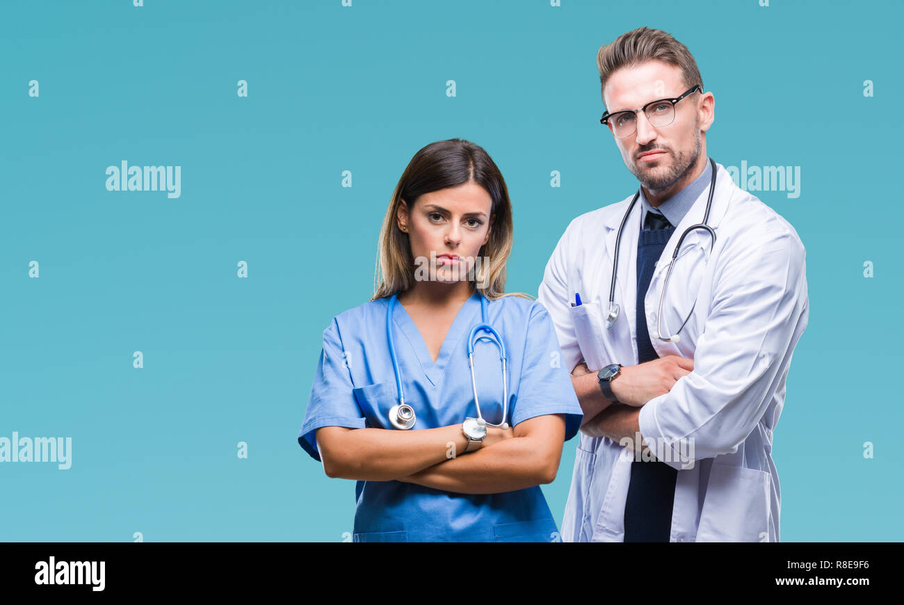 Young couple of doctor and surgeon over isolated background skeptic and ...