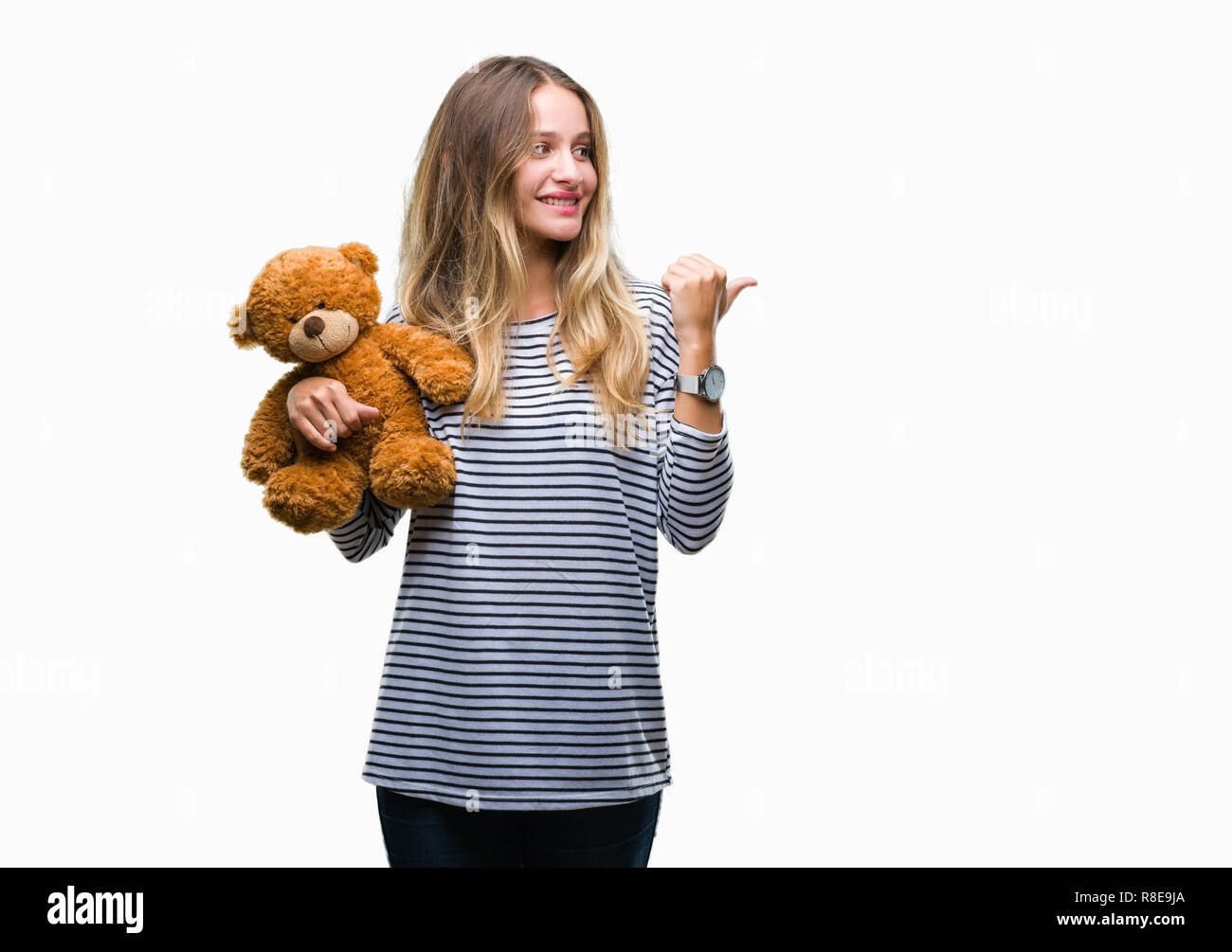 Young beautiful blonde woman holding teddy bear plush over isolated ...