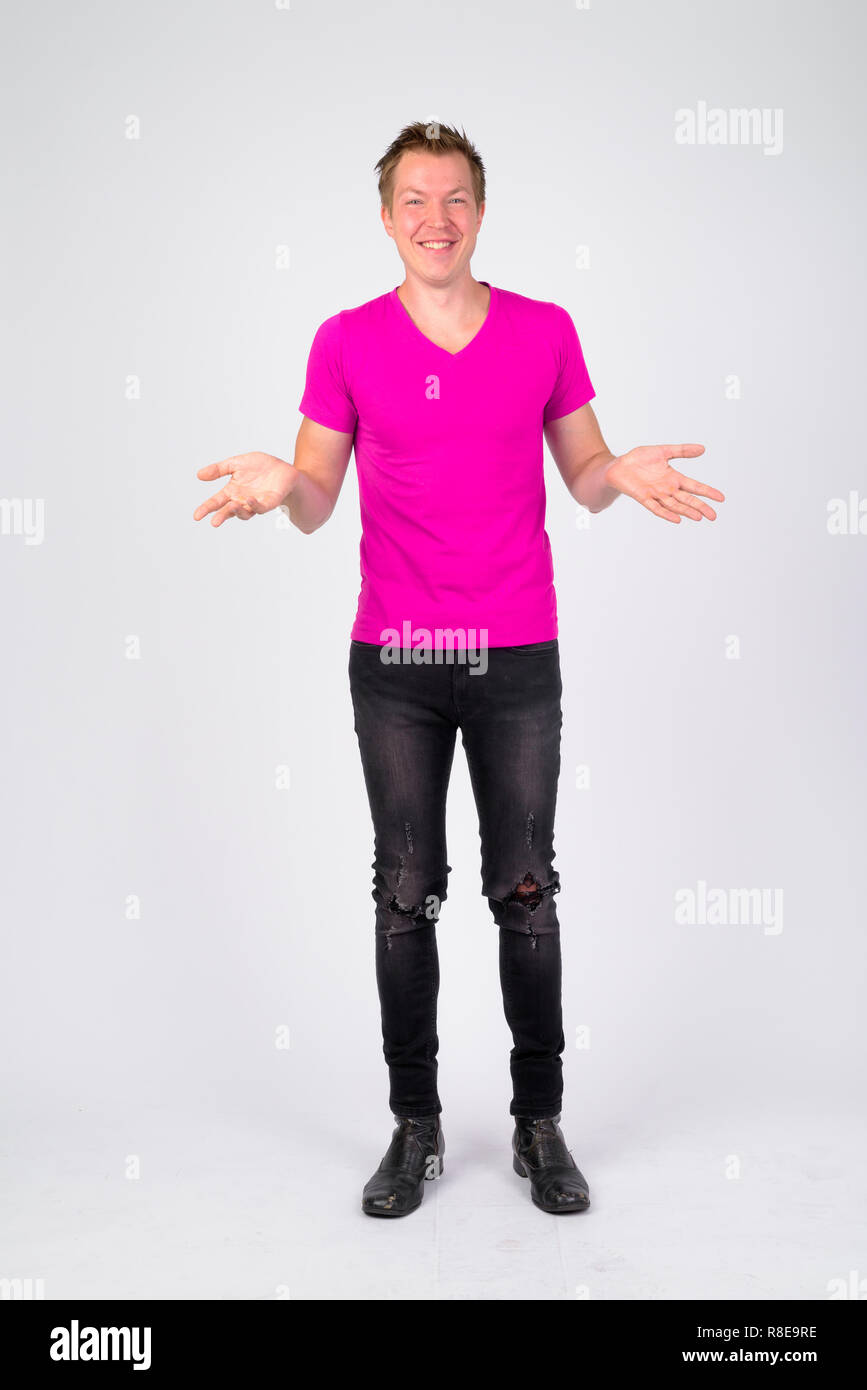 Full body shot of happy young handsome man shrugging shoulders Stock ...