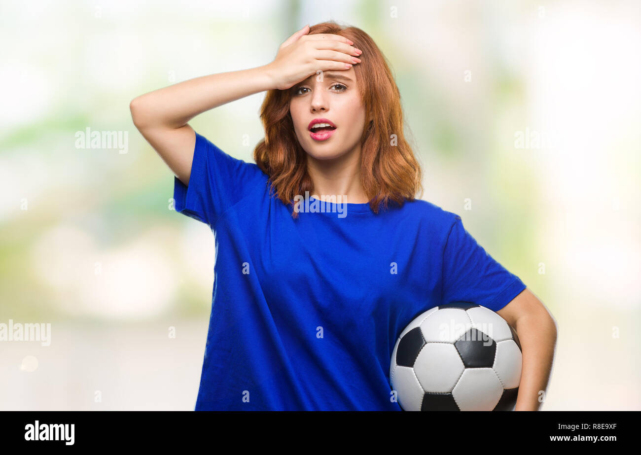 Young beautiful woman over isolated background holding soccer football ...