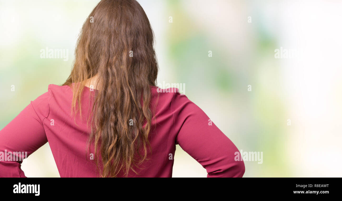 Beautiful plus size young woman over isolated background standing ...