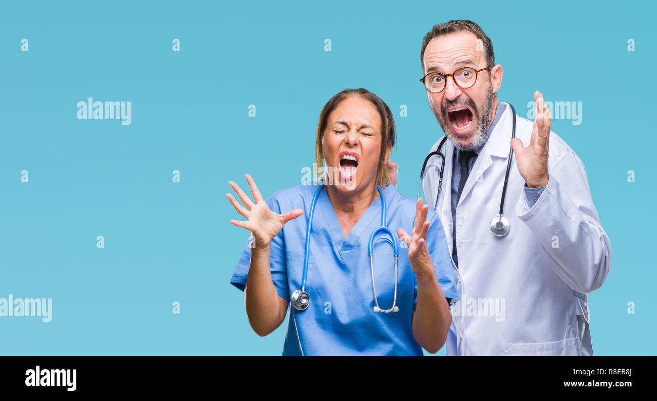 Middle age hispanic doctors partners couple wearing medical uniform ...