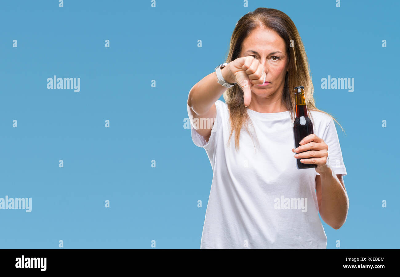 Middle age hispanic woman drinking beer over isolated background with ...