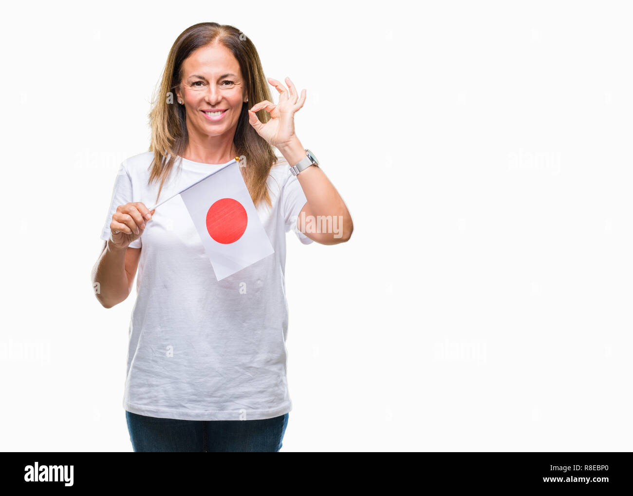 Middle age hispanic woman holding flag of Japan over isolated ...