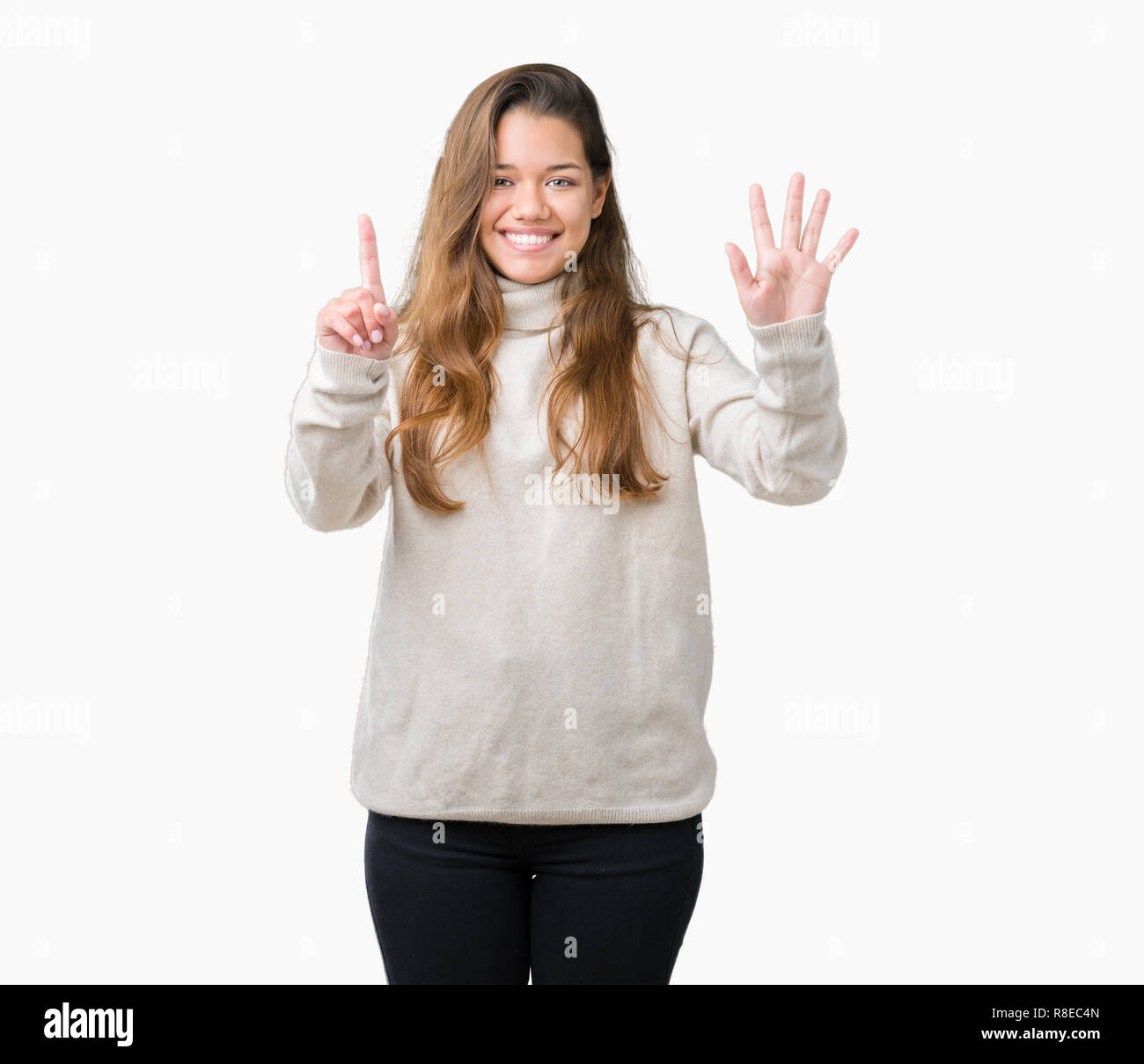 Young beautiful brunette woman wearing turtleneck sweater over isolated ...