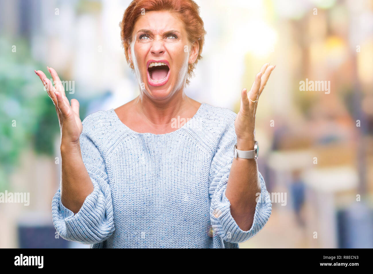 Atrractive senior caucasian redhead woman wearing winter sweater over ...