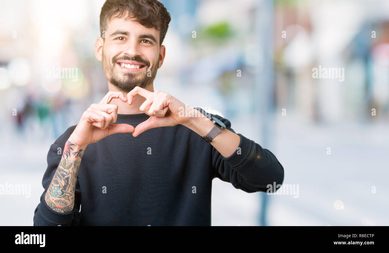 Young handsome man over isolated background smiling in love showing ...