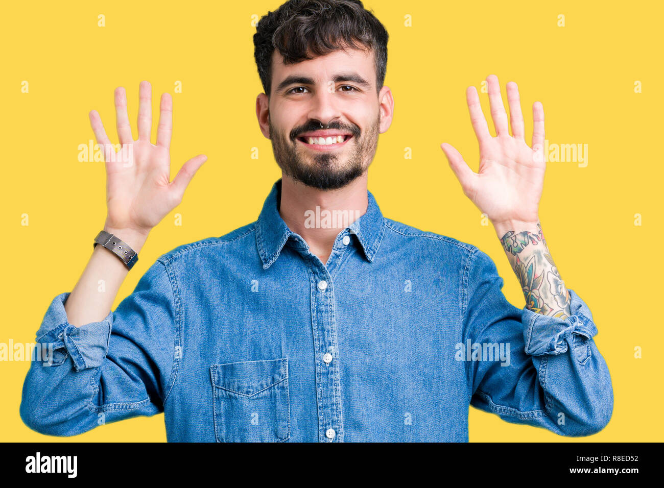 Young handsome man over isolated background showing and pointing up ...