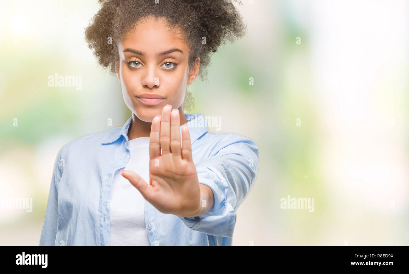 Young afro american woman over isolated background doing stop sing with ...