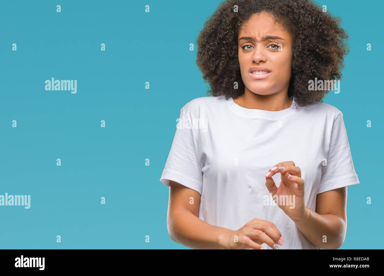 Young afro american woman over isolated background disgusted expression ...
