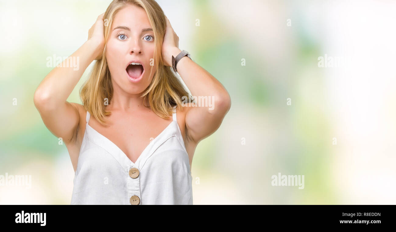 Beautiful young woman over isolated background Crazy and scared with ...