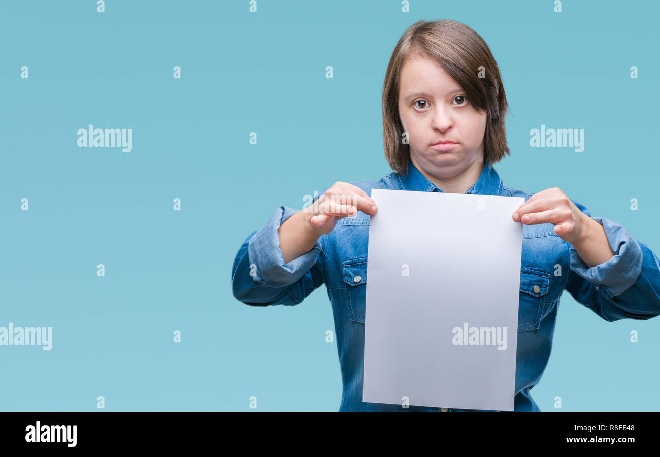 Young adult woman with down syndrome holding blank paper sheet over ...