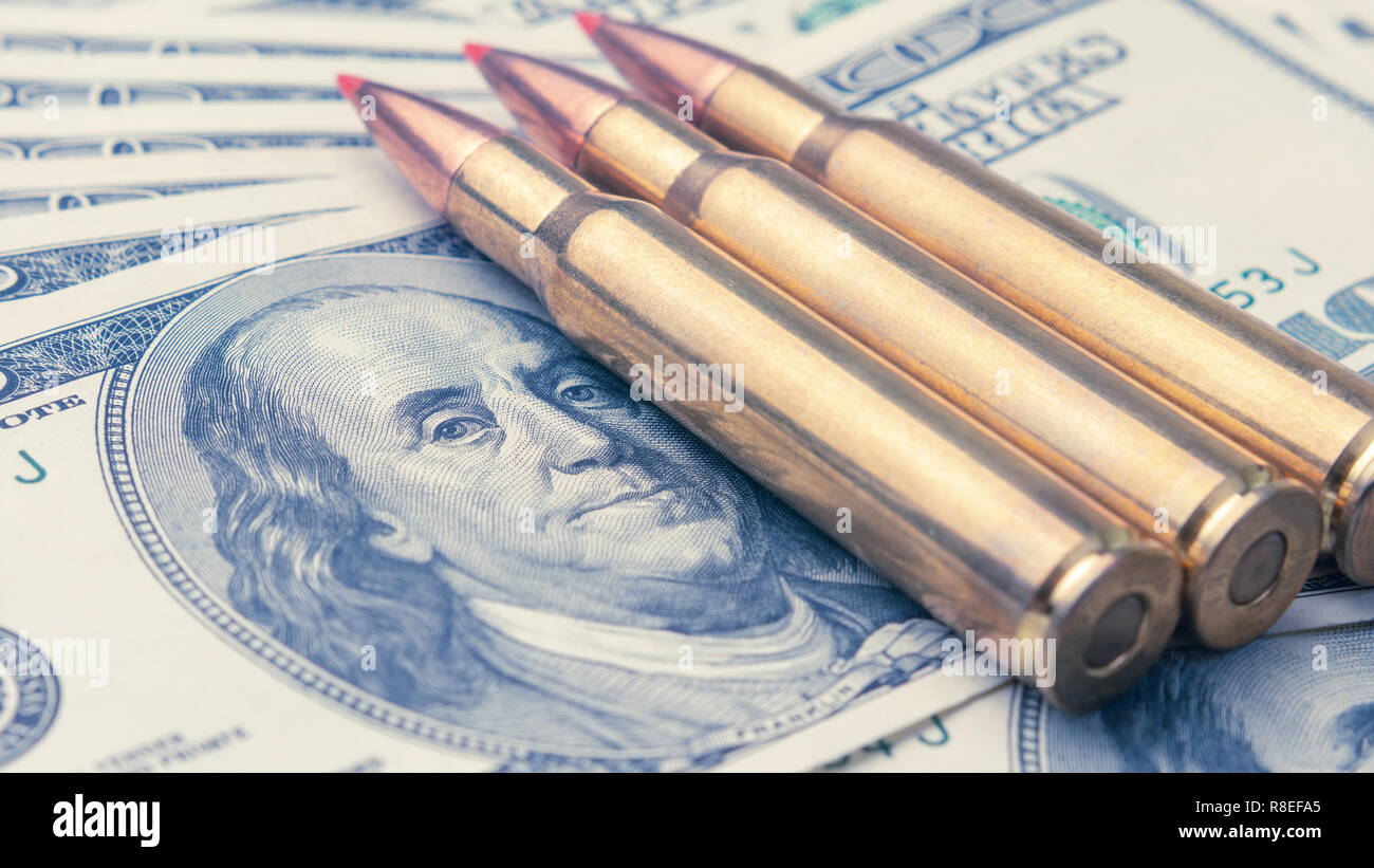 on the banknotes of dollars are fighting bullets close-up. Concept of ...