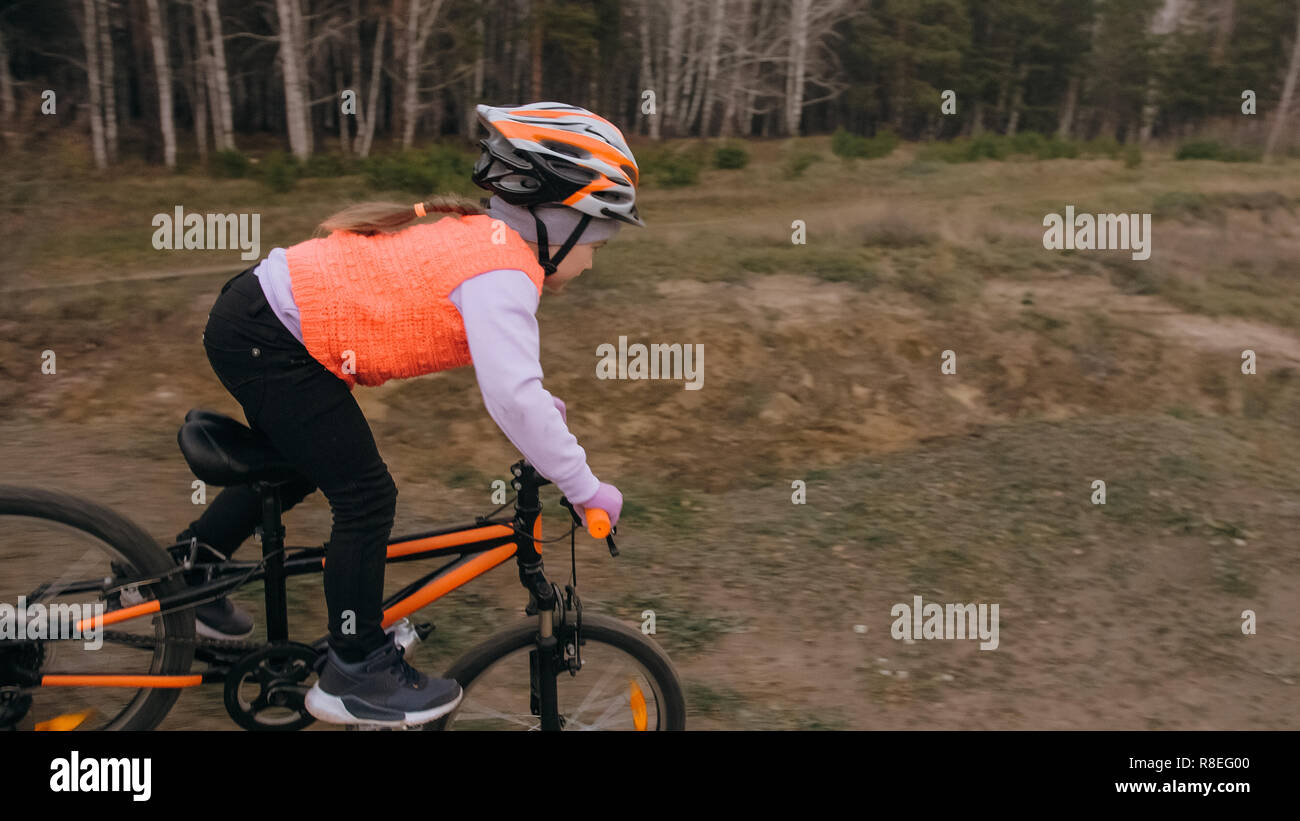 One caucasian children rides bike road track in dirt park. Girl riding ...