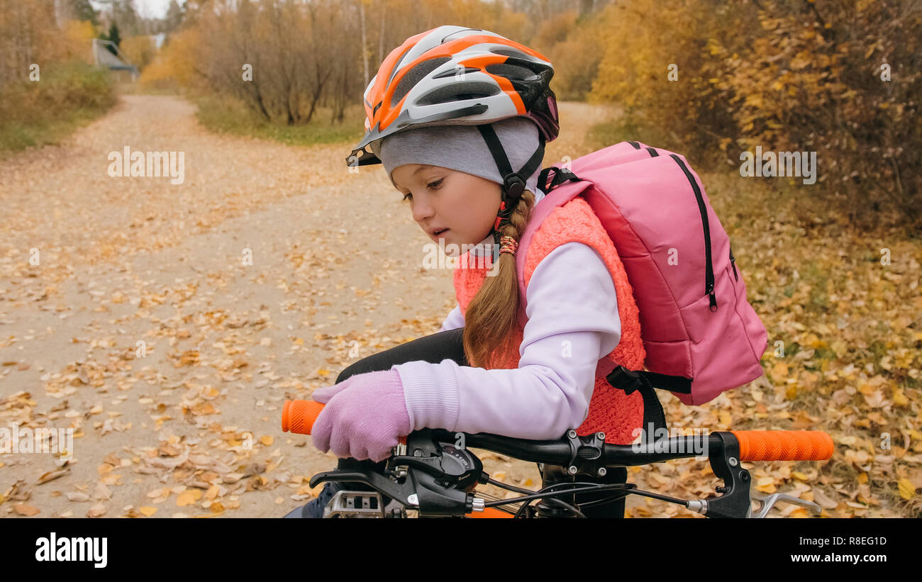 One caucasian children walk with bike in autumn park. Little girl ...